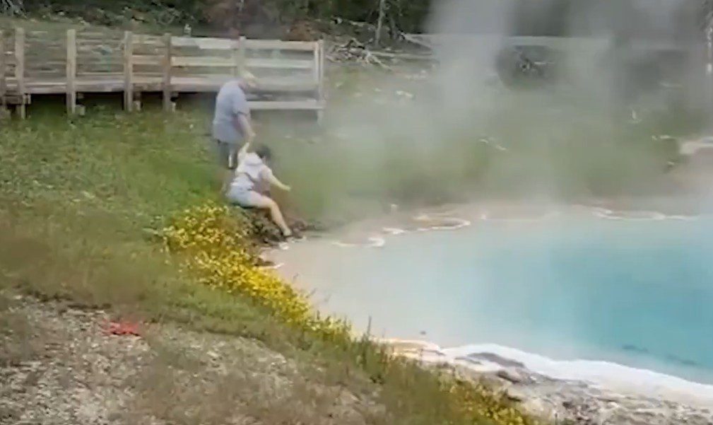 Father Helps His Daughter Dip Her Hand In Hot Spring At Yellowstone ...